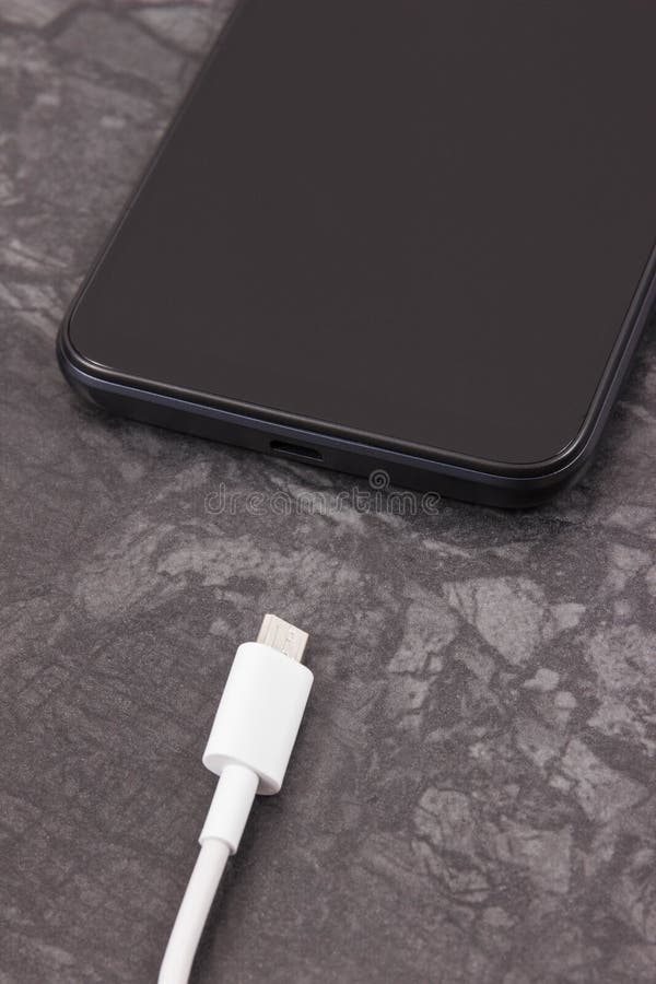 Black Smartphone and Unconnected Cable of Charger. Telephone Charging ...