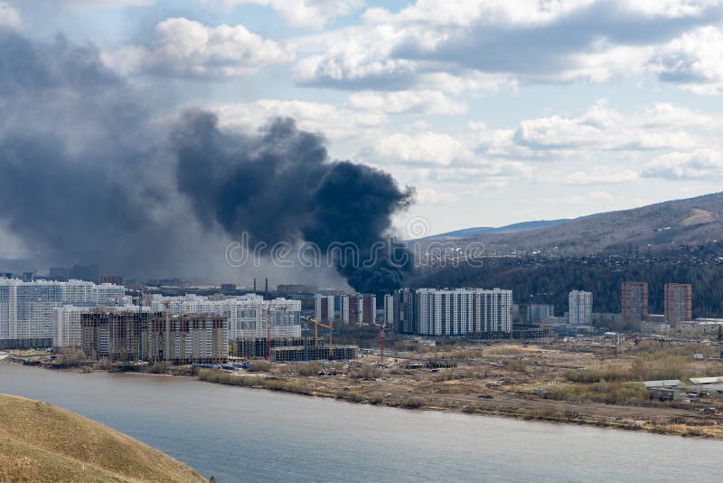 Black Smoke from a Fire in a City on the Other Side of the River. Stock ...