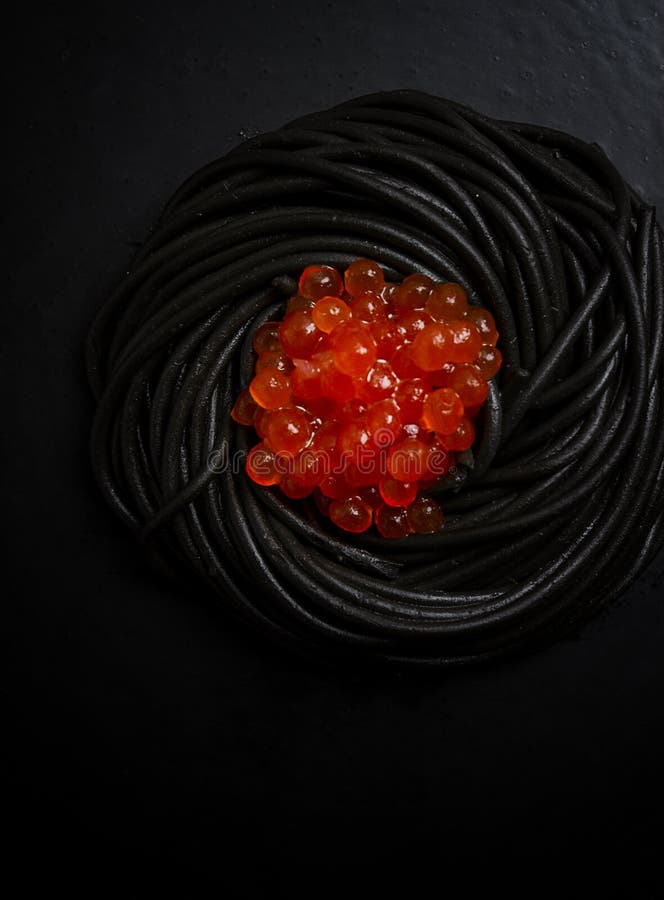 Black Spaghetti with Red Caviar, Pasta, on a Black Background, Top View ...