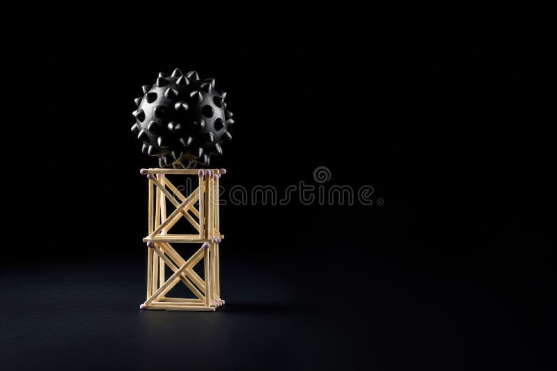 A Black Spiked Ball is Balancing on a Tower of Matches. Space for Text ...