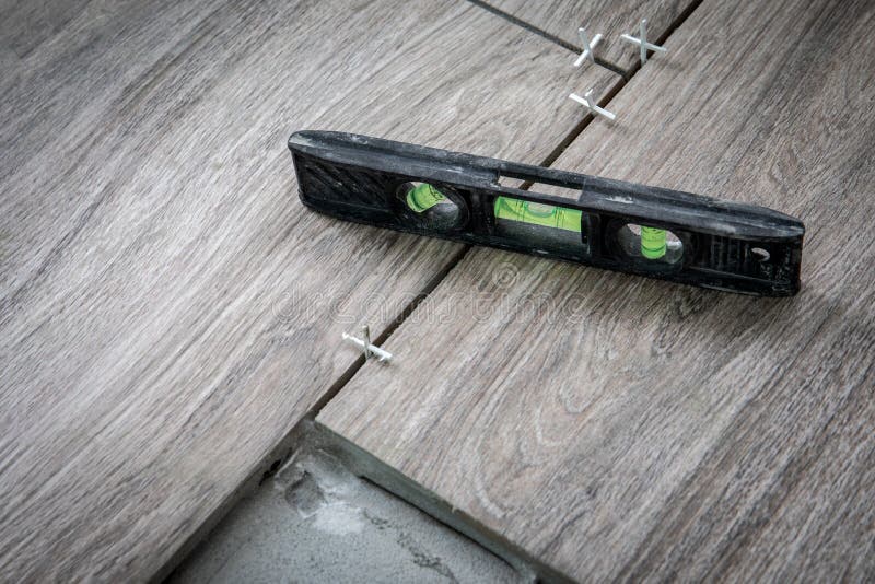 Black Spirit Level on Tiles. Tiling Works, Renovation and Construction ...