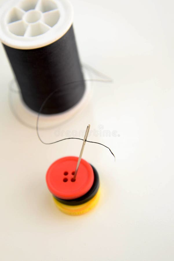 Black Spool of Thread, Needle, and Black and White Buttons Stock Photo ...