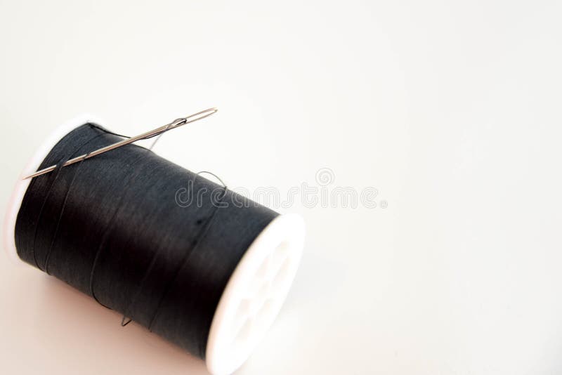 Black Spool of Thread, Needle, and Black and White Buttons Stock Photo ...