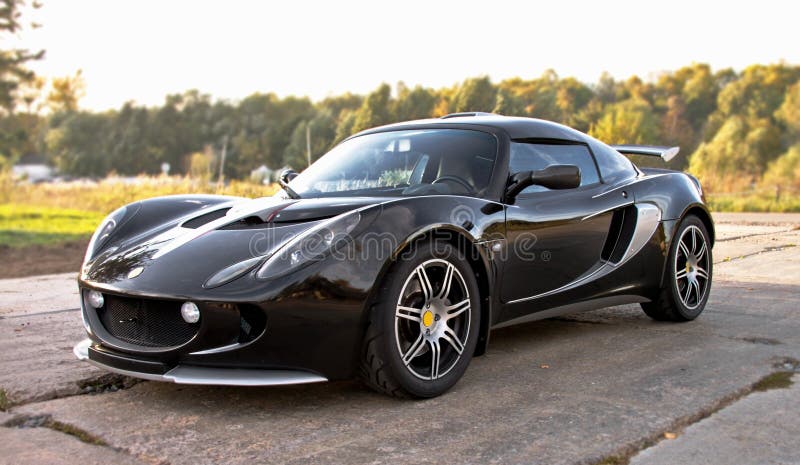 Black Sport Car on Big Wheels on Nature Background Stock Photo - Image ...