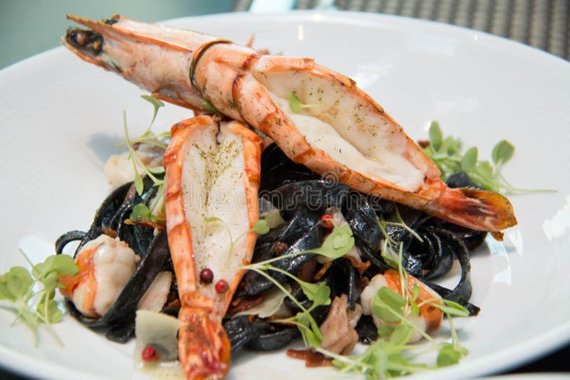 Black Squid Ink Pasta is Paired with Scallops on Pasta Stock Image ...