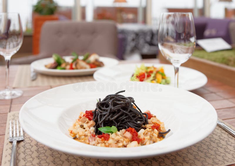Black Squid Ink Pasta with Seafood and Other Dishes Stock Image - Image ...