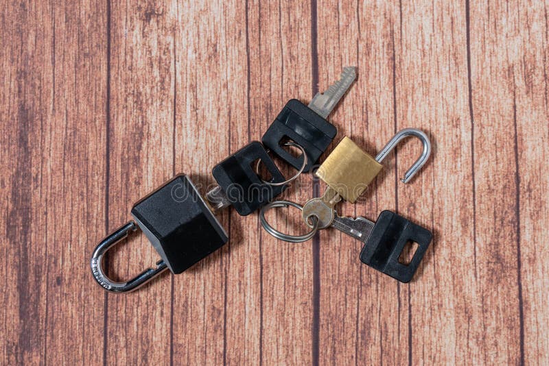 Black Steel Padlock with Keys on a Wooden Background. Concept of ...