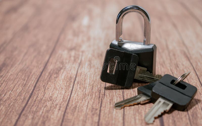 Black Steel Padlock with Keys on a Wooden Background. Concept of ...