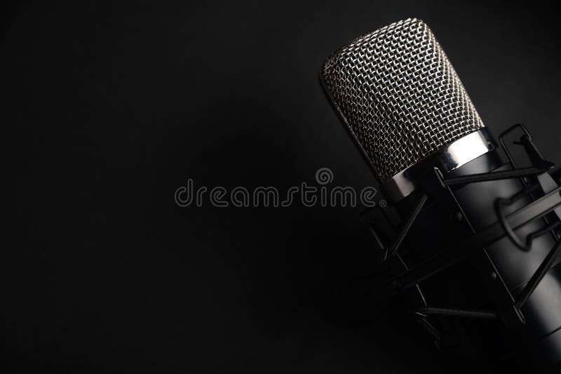Black Studio Microphone on a Black Background with a Pop Filter with ...