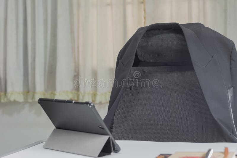 Black Suit Hang on Chair Behind White Table and Tablet Stock Photo ...