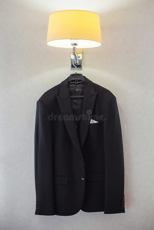 Black Suit Jacket Hanging Under Lamp Stock Image - Image of room ...