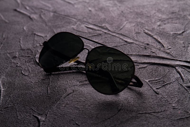 Black Sunglasses on a Dark Raised Surface. Stock Photo - Image of ...