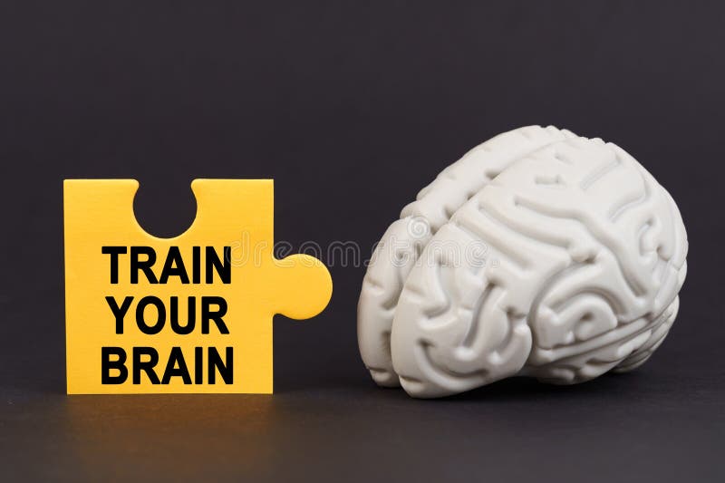 On a Black Surface There is a Brain and a Yellow Puzzle with the ...