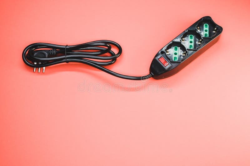 Black Surge Protector on a Light Red Background Stock Image - Image of ...