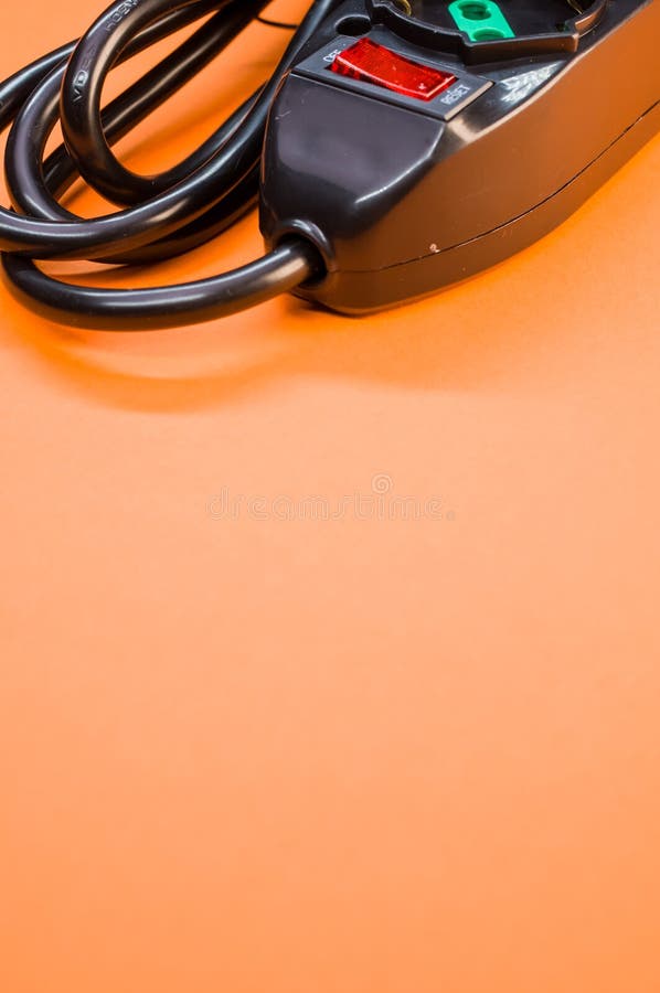 Black Surge Protector on an Orange Background Stock Image - Image of ...