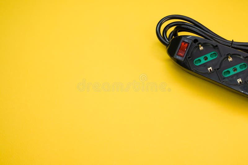 Black Surge Protector on a Yellow Background Stock Photo - Image of ...