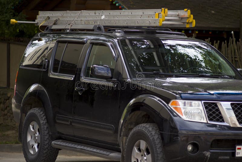Black SUV aluminum ladder stock image. Image of vehicle - 193986685