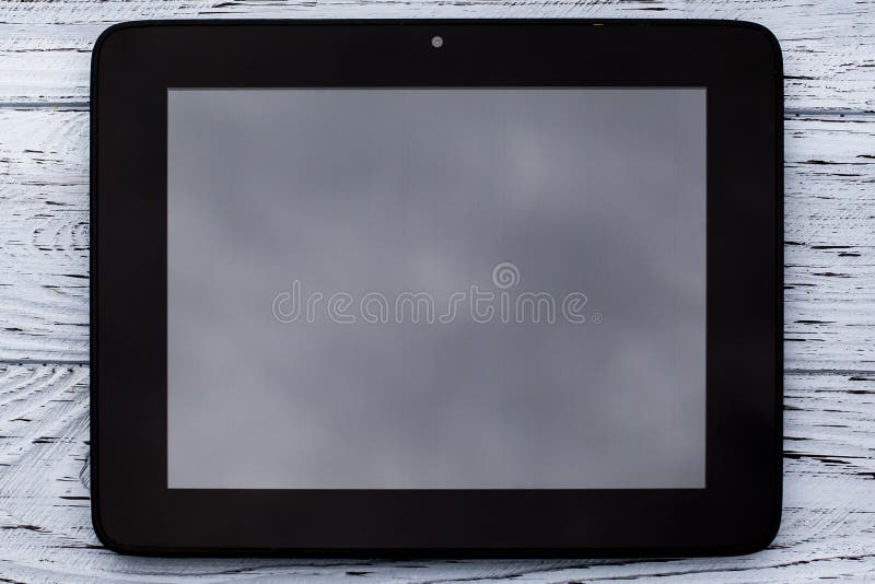 A Black Tablet with a Blank Display without an Image Lies on a Light ...