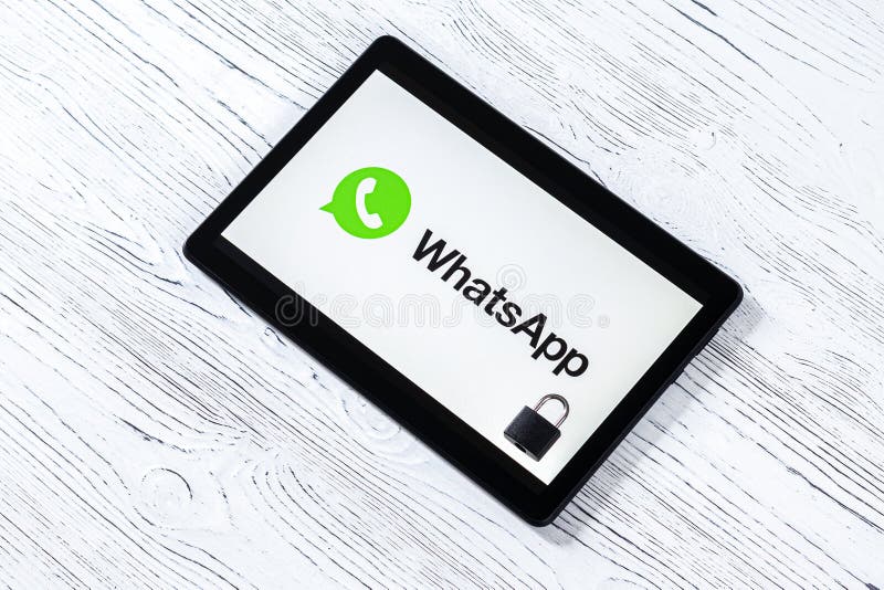 Black Tablet Computer on a White Wooden Table with a Messenger Whatsapp ...