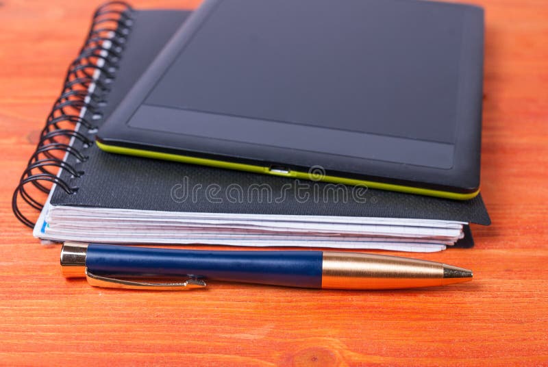 Black Tablet, Pen, and the Diary Lying on a Wooden Table. Stock Image ...