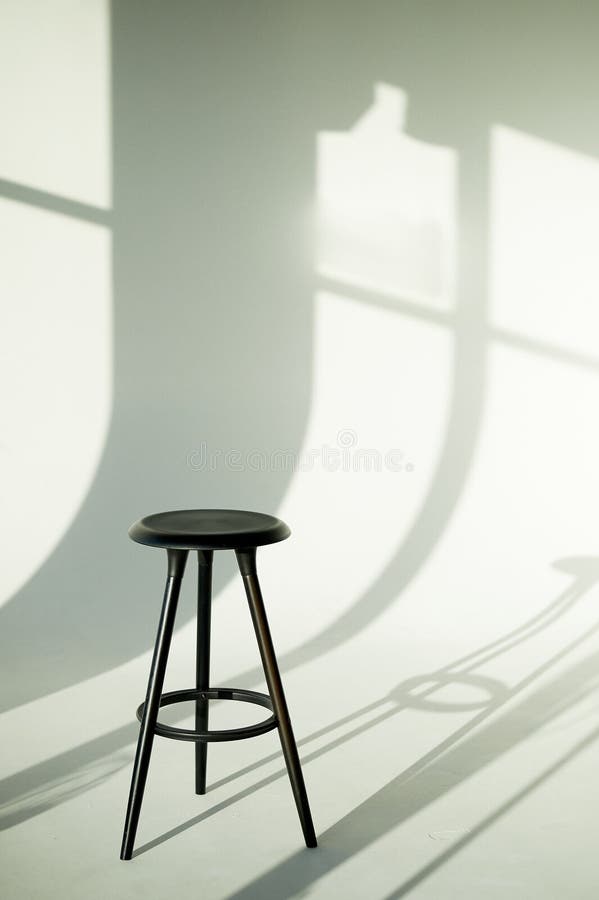 A Black Tall Stool on Three Legs in a White Studio Bathed in Light ...