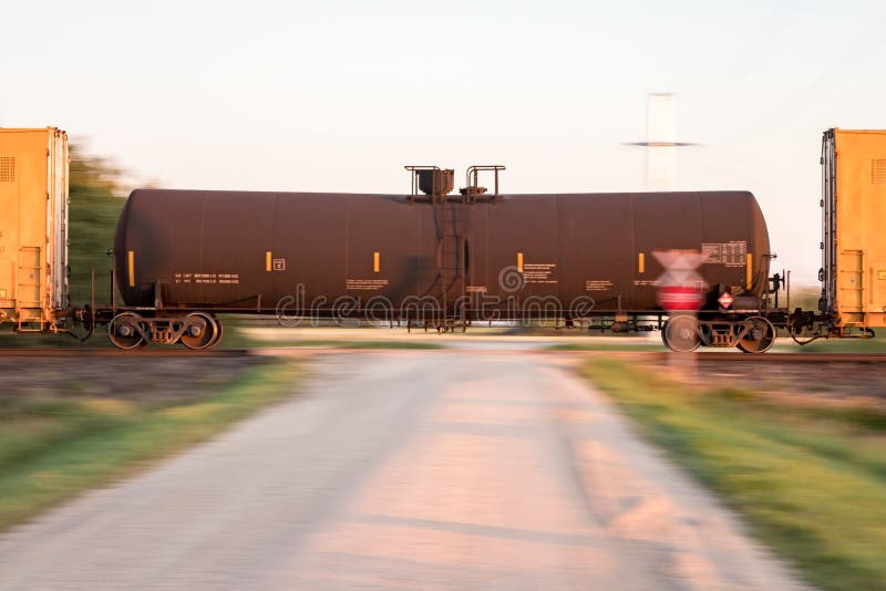 Black Tank Car Speeding through Road Crossing at Sunset Stock Image ...