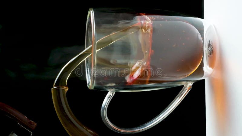 Black Tea from the Kettle is Poured into a Glass Cup with a Double ...