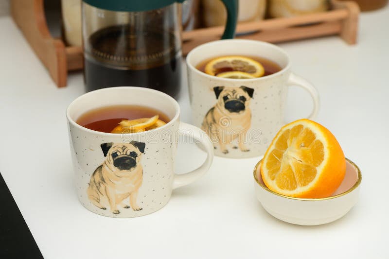 Black Tea with Lemon in Cups with a Drawn Pug 2 Stock Image - Image of ...