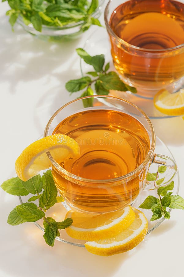 Black Tea with Mint and Lemon on a White Table Stock Photo - Image of ...