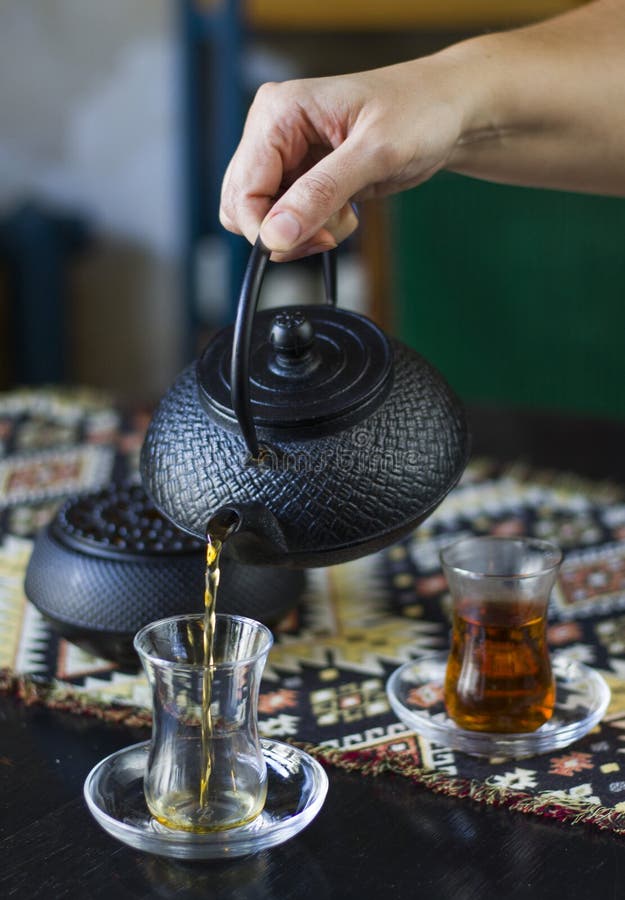 Black Tea and Teapot in Hand, Turkish Tea Glasses Stock Image - Image ...