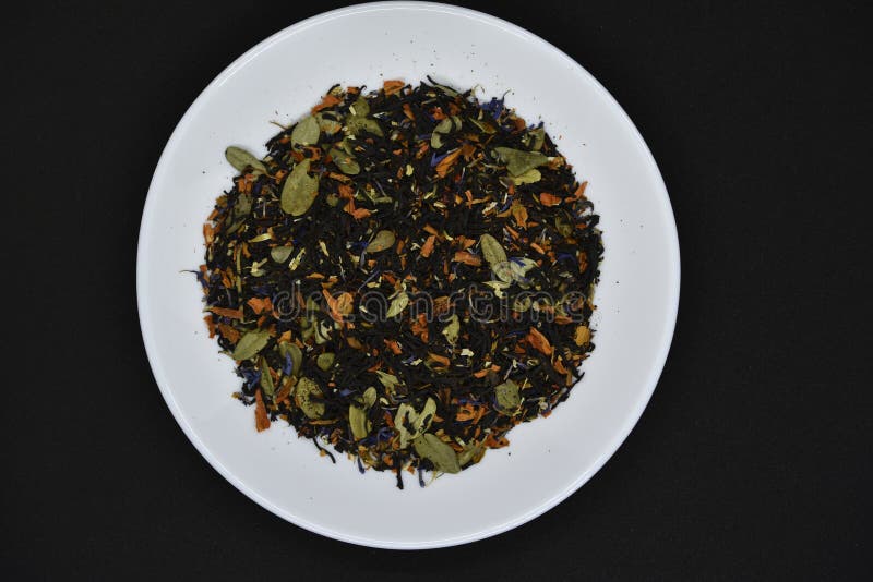 Black Tea on a White Plate. Dry Tea with Spices for Brewing Stock Image ...