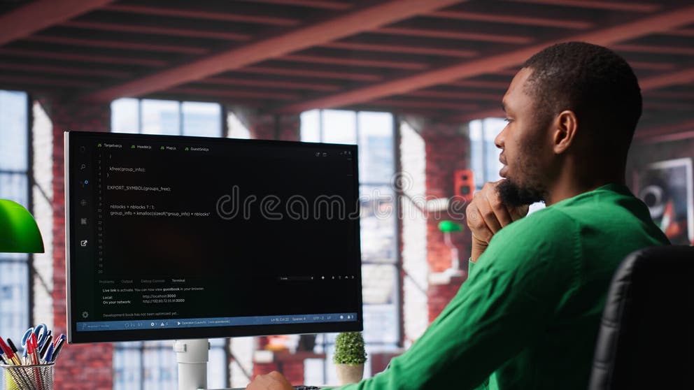 Black Technician in Home Office Looks at UI on Computer Monitor Stock ...