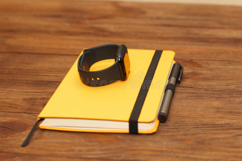 A Black Technological Smart Watch Lies on a Notepad for Time Management ...