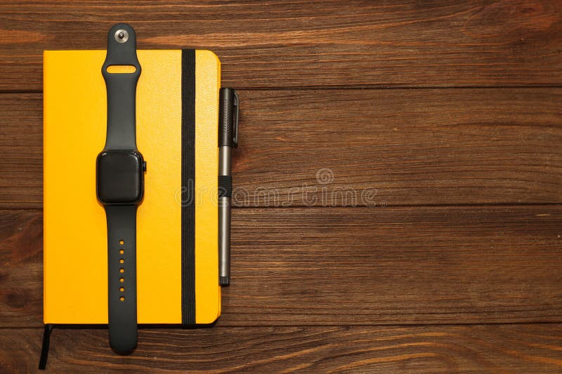 A Black Technological Smart Watch Lies on a Notepad for Time Management ...