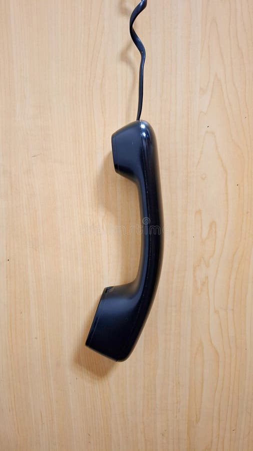 A Black Telephone Receiver Hung from a Wire. the Phone Was Upside Down ...