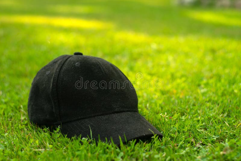 Black Textile Cap on Green Grass, Background Blur, Space for Text Stock ...