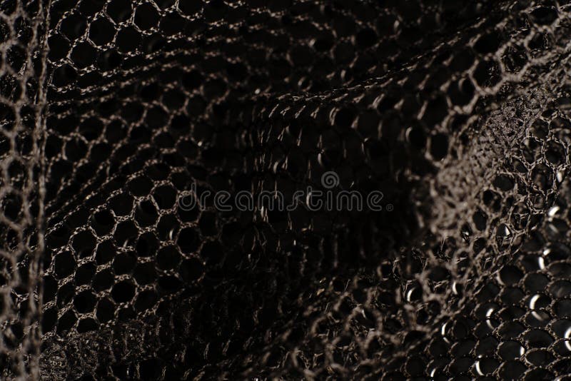 Black Texture. a Black Net is Placed on a Black Perforated Metal Table ...