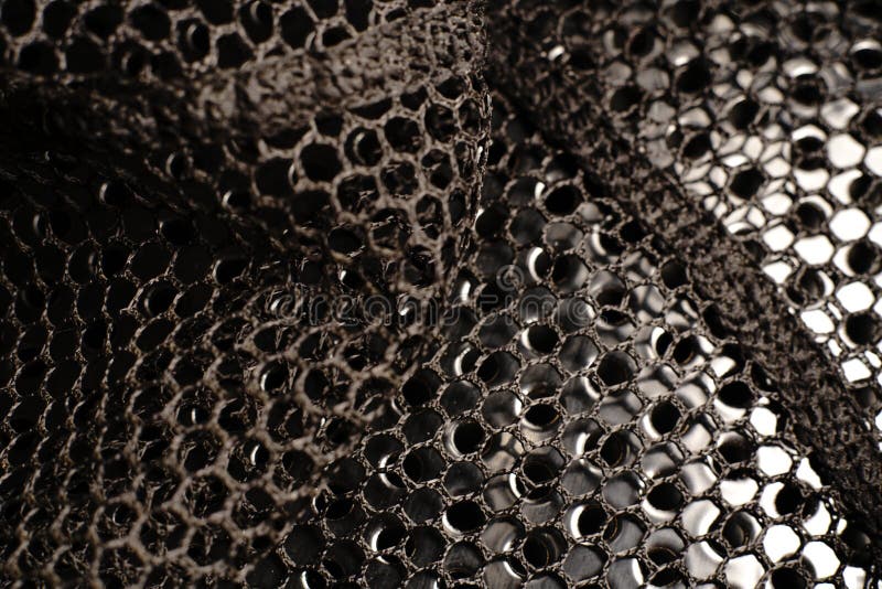 Black Texture. a Black Net is Placed on a Black Perforated Metal Table ...