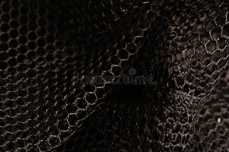Black Texture. a Black Net is Placed on a Black Perforated Metal Table ...