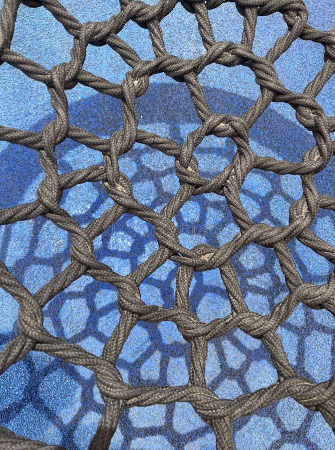 Black Thick Woven Mesh on the Blue Background with a Shadow from it ...