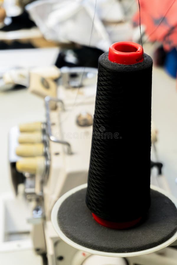 Black Thread Spool on a Sewing Machine in a Bright Workshop Stock Image ...