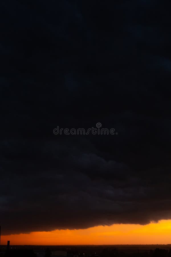 Black Thunderclouds at Sunset. Bright Orange Sunset and Dark Clouds ...