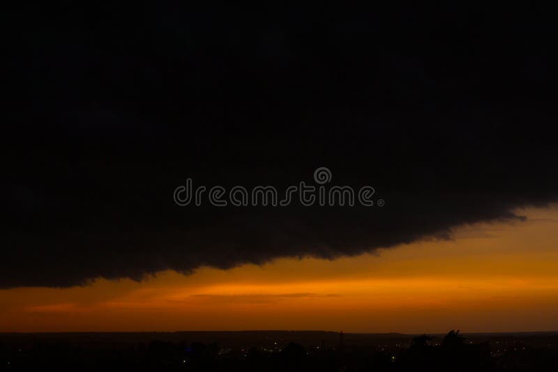 Black Thunderclouds at Sunset. Bright Orange Sunset and Dark Clouds ...