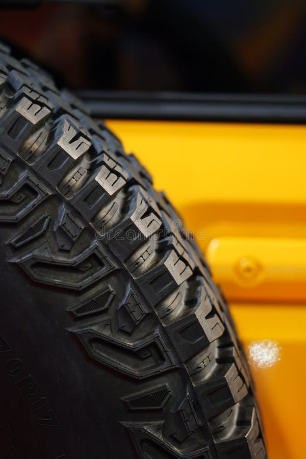 Black tire on a yellow car stock photo. Image of black - 267031146