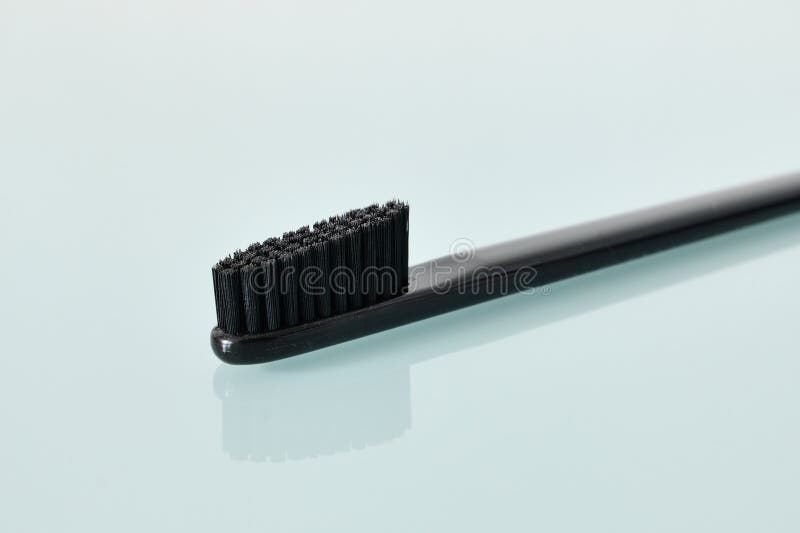 Black Toothbrush on a Light Blue Background Stock Photo - Image of ...