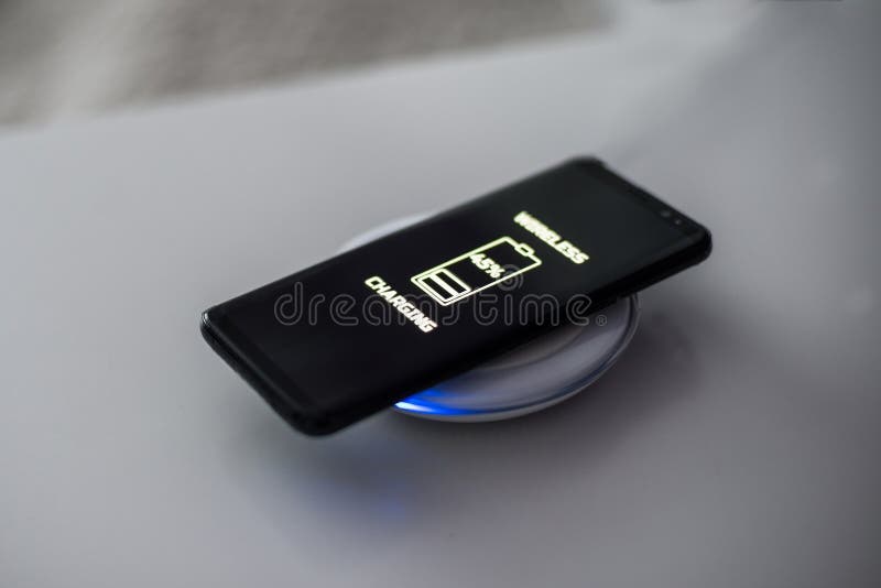 Black Touchscreen Smartphone Wireless Charging on Induction Charger ...