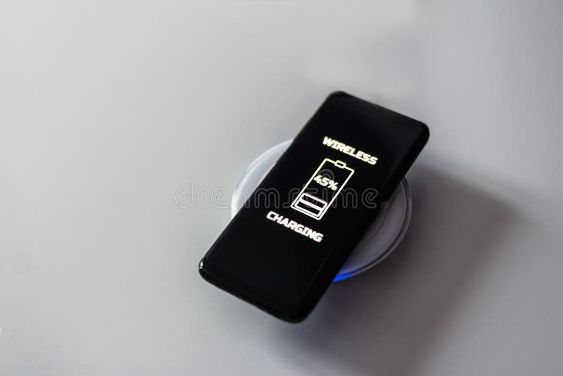 Black Touchscreen Smartphone Wireless Charging on Induction Charger ...