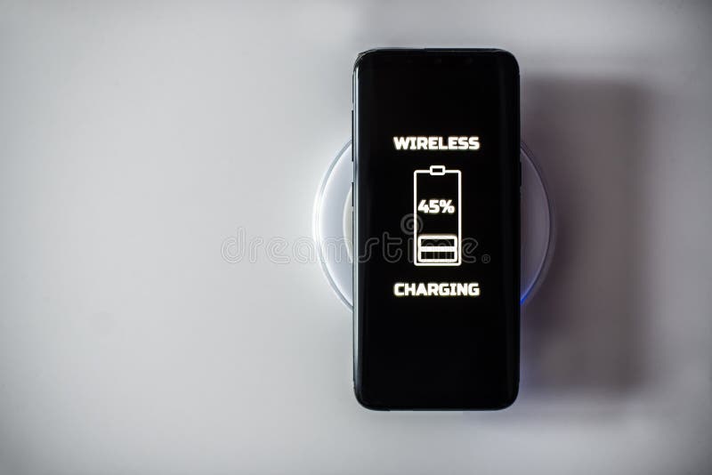 Black Touchscreen Smartphone Wireless Charging on Induction Charger ...