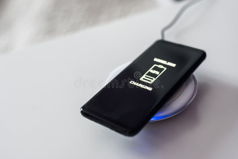 Black Touchscreen Smartphone Wireless Charging on Induction Charger ...