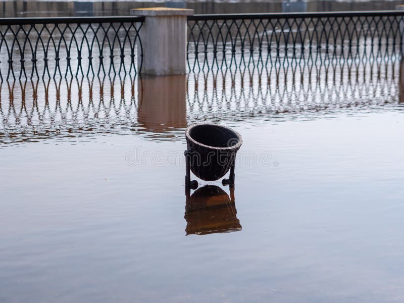 Black Trash Can in a Puddle on a Bridge in City Stock Photo - Image of ...
